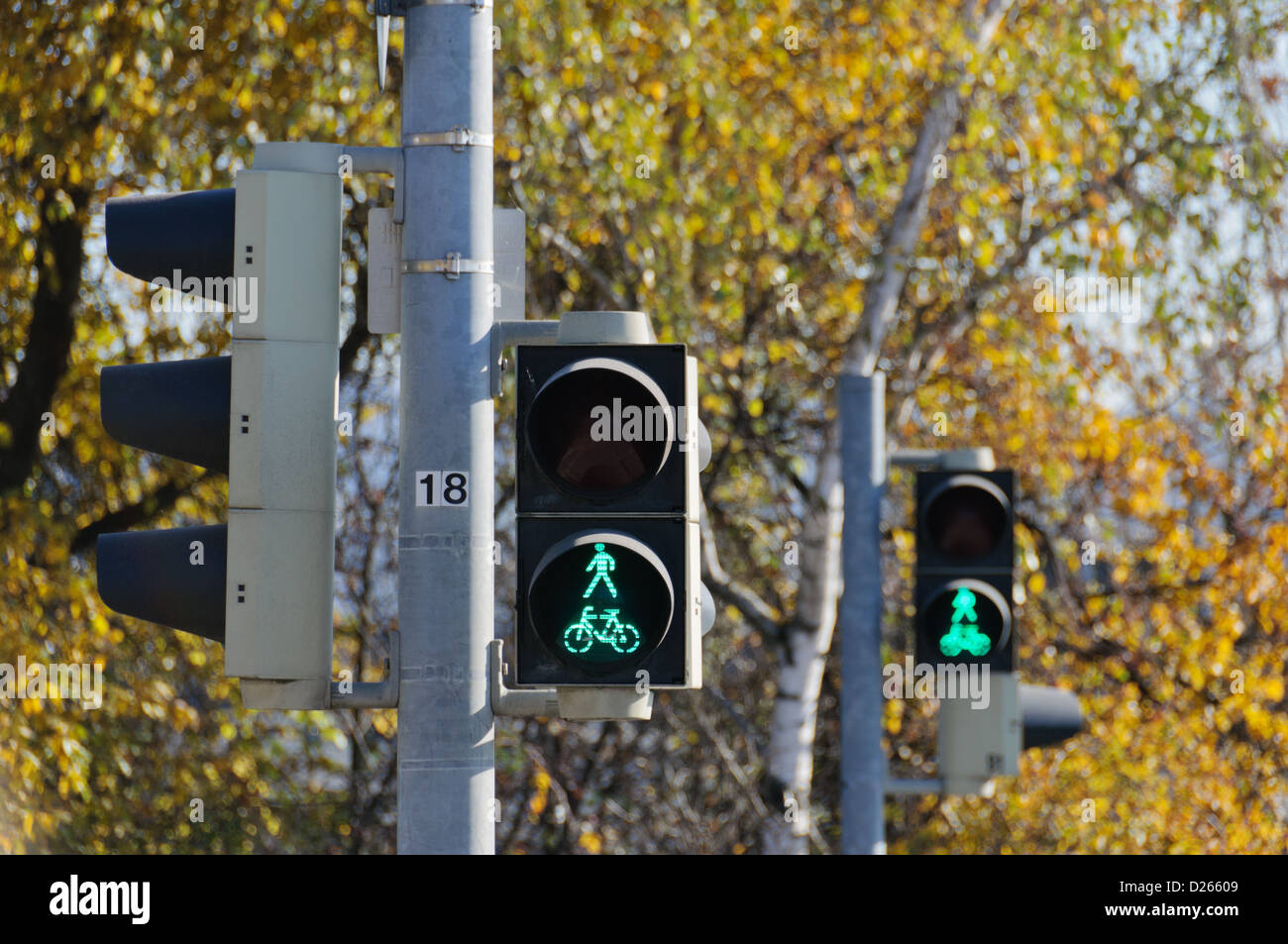 Green pedestrian and cyclist crossing lights Stock Photo - Alamy