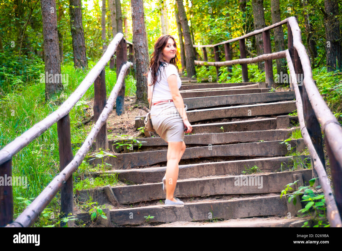 An image o girl walking through the forest pathway Stock Photo - Alamy