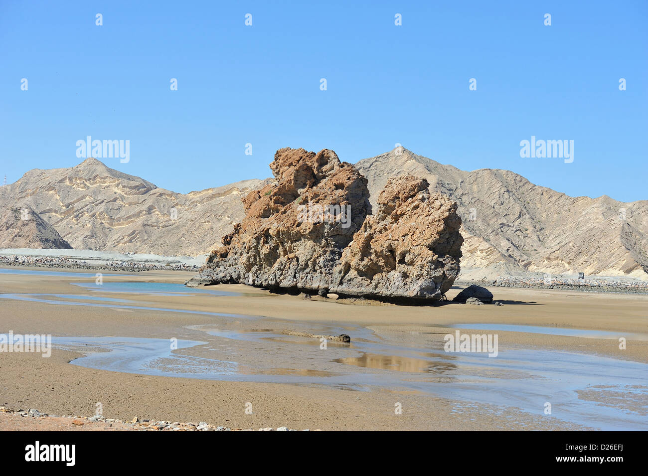Weird rock formations at low tide in the beach village at Yiti; Muscat ...