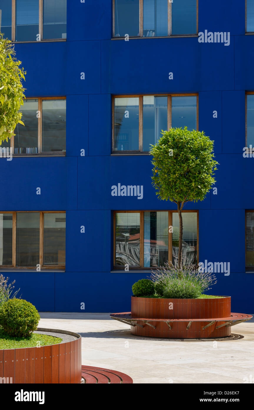 Blue wall and decoration trees on front of the Guggenheim Bilbao museum ...