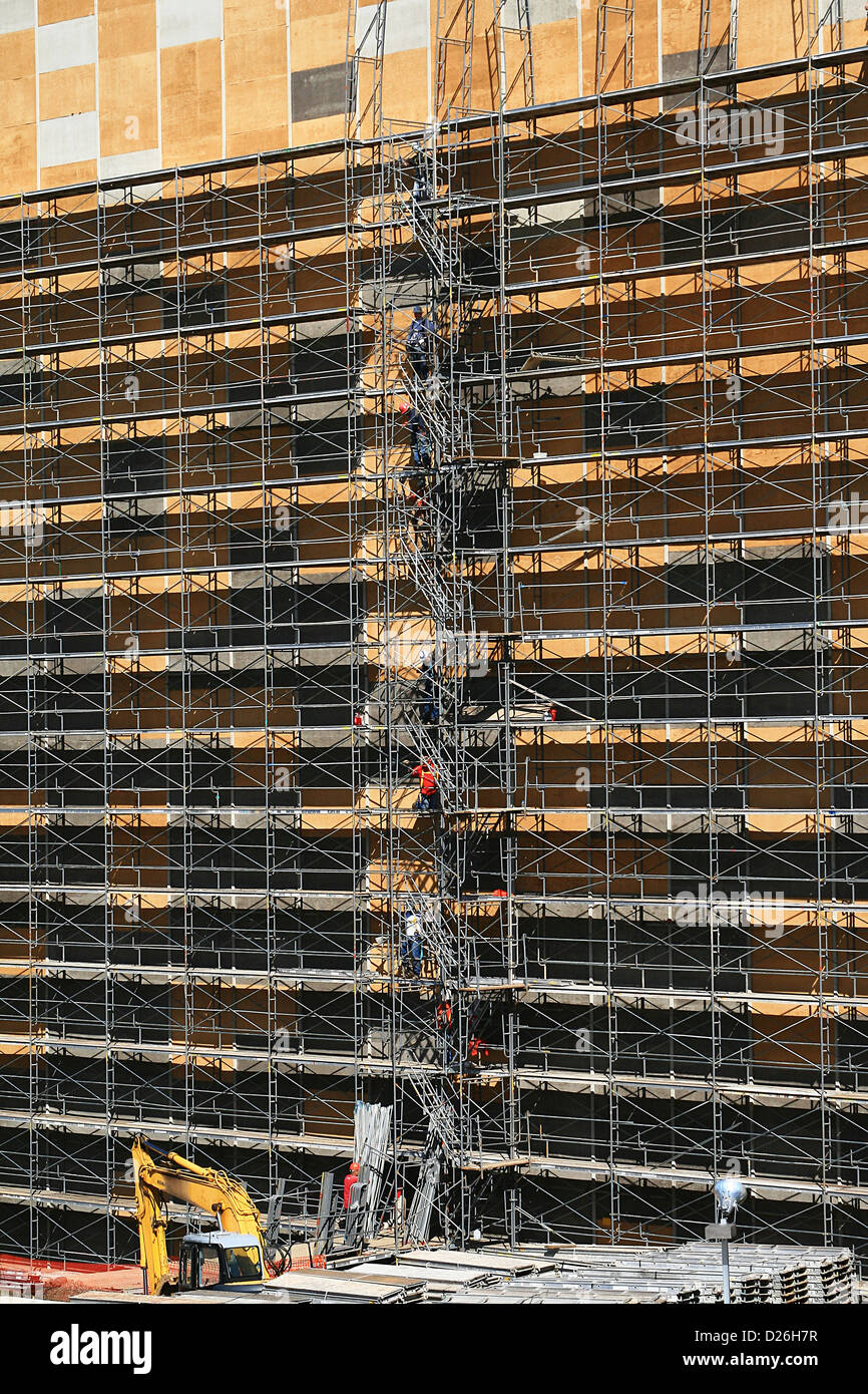 Construction workers climb scaffold Stock Photo - Alamy