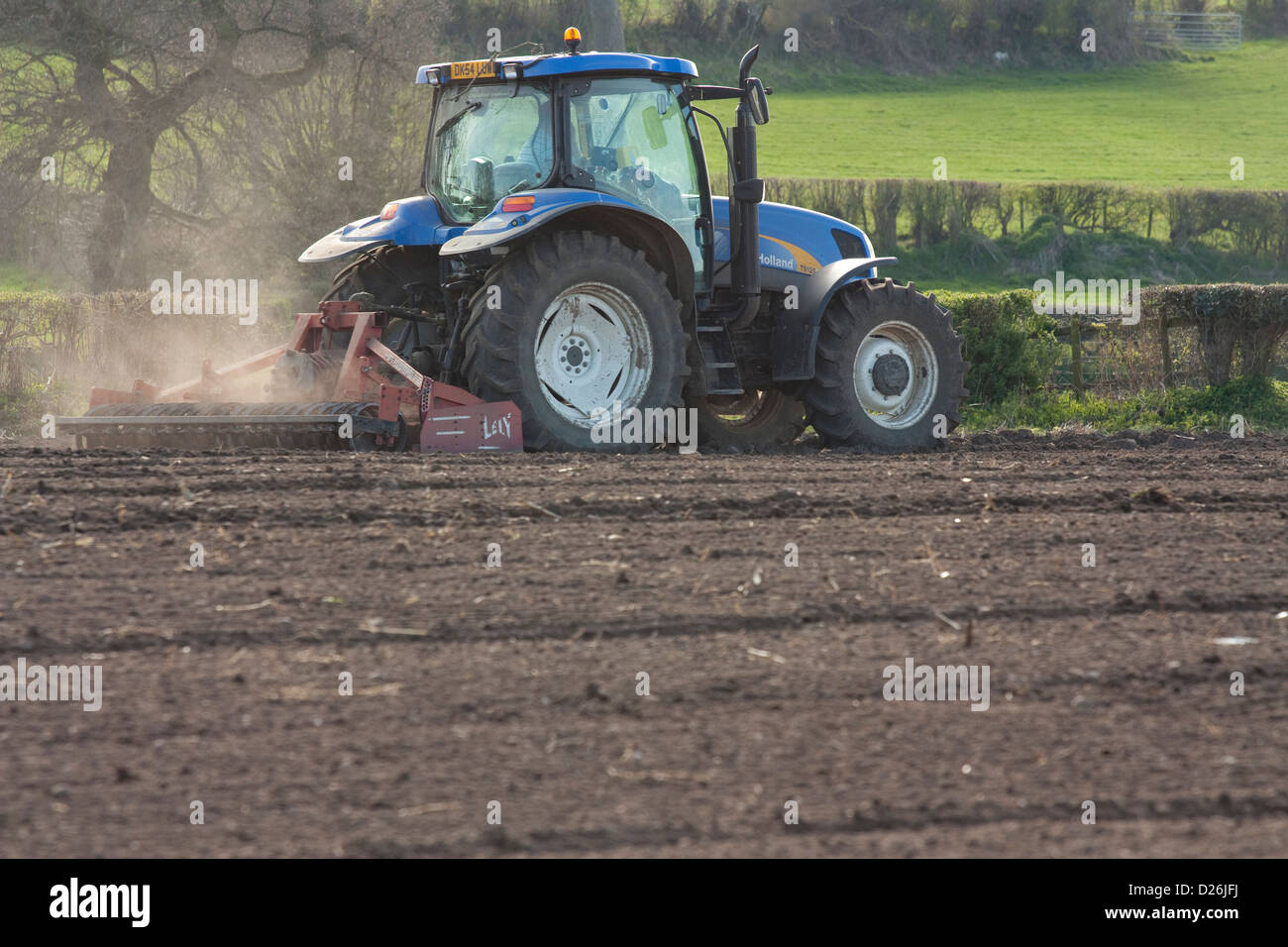 Tractor ploughing rural field for planting Stock Photo - Alamy