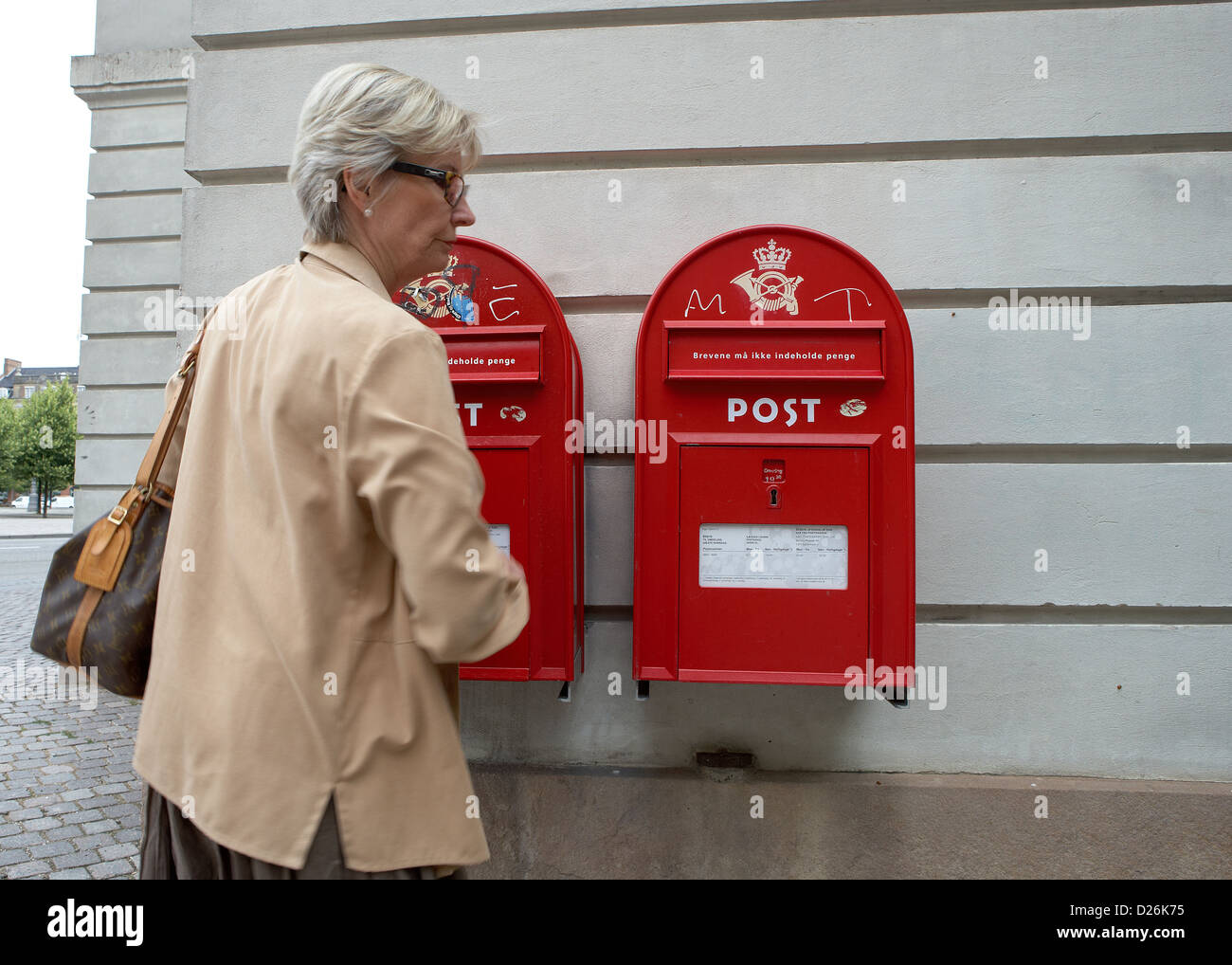 Copenhagen, Denmark, a woman, two red mailbox the Danish Post Stock ...
