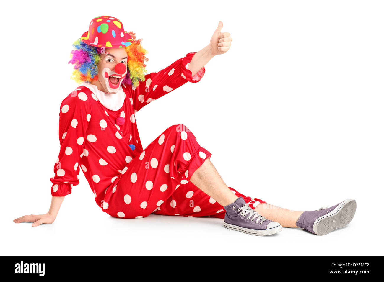 A clown with smiling joyful expression sitting down and giving thumb up ...