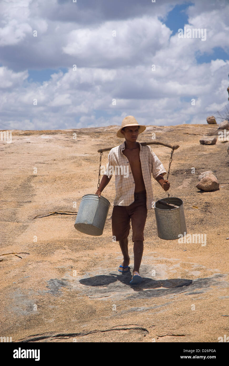 Man Carrying Water Stock Photo - Alamy