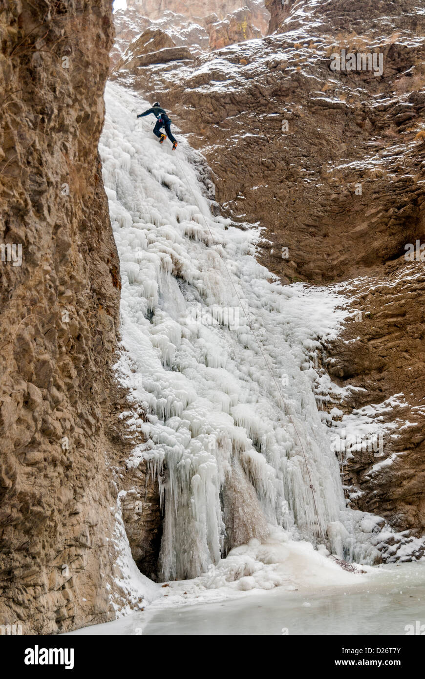 Ice climber accents a wall of an ice waterfall Stock Photo - Alamy