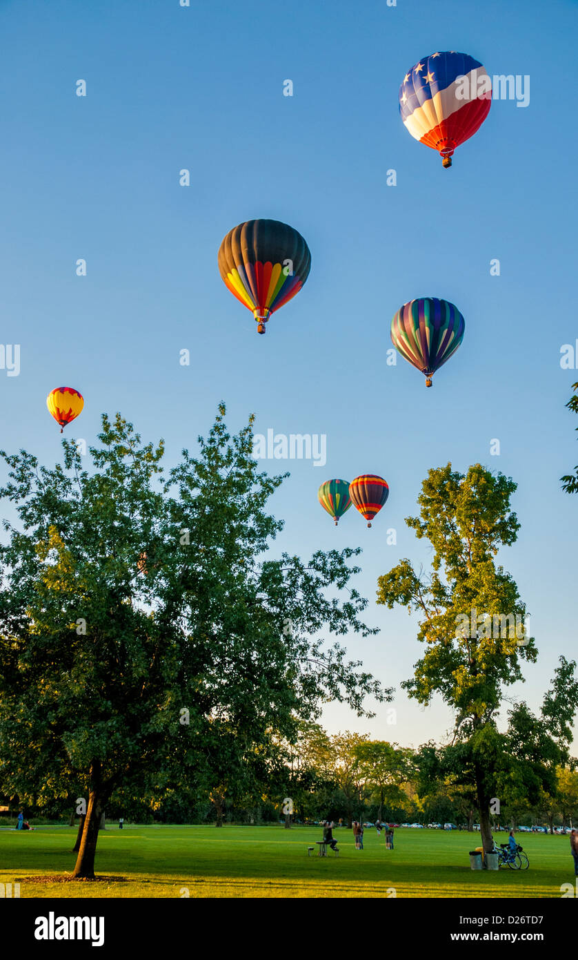Many balloons lift off in a city Stock Photo - Alamy