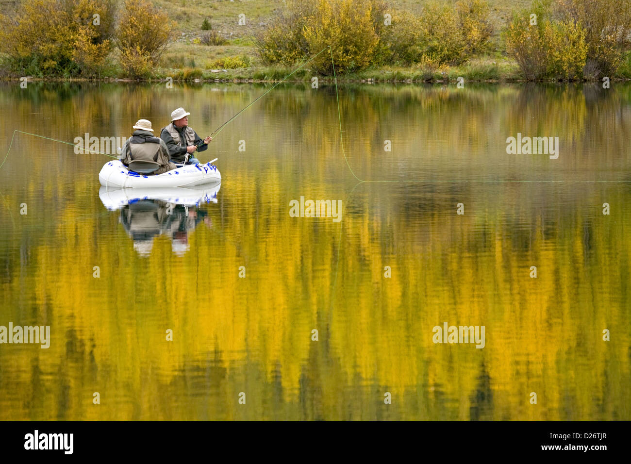 Two adult men fishing in Crystal Lake in autumn near Ouray, Colorado ...