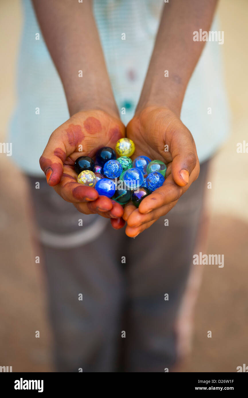 Indian boys hands holding marbles hi-res stock photography and images ...