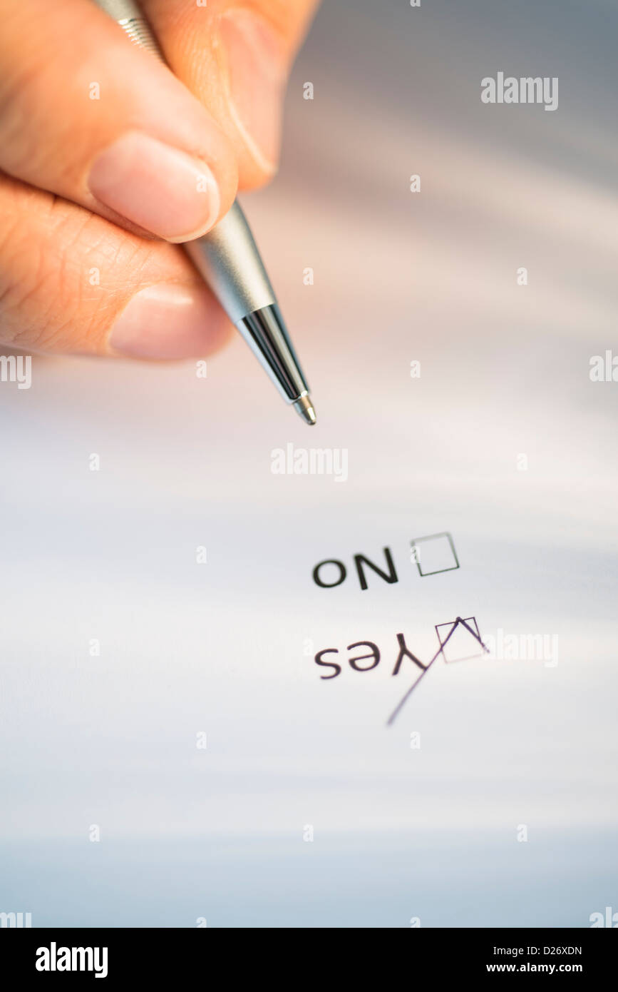Close-up of hand filling out form Stock Photo - Alamy