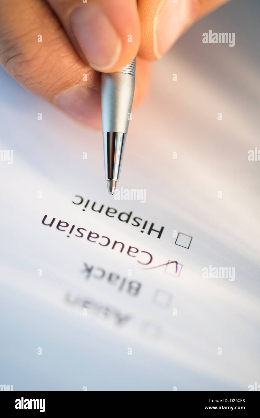 Close-up of hand filling out form Stock Photo - Alamy