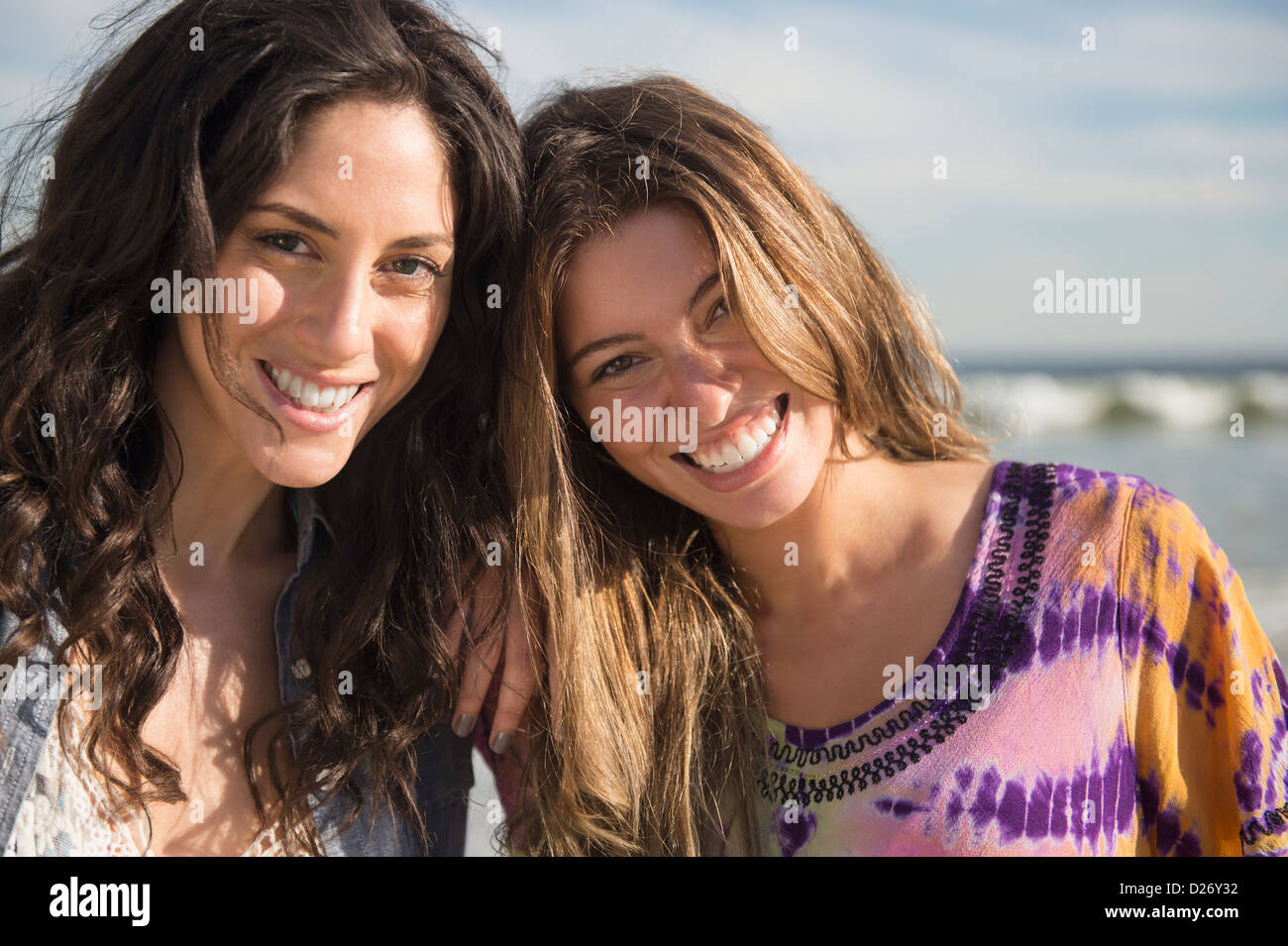 USA, New York State, Rockaway Beach, Portrait of two young women on ... USA, New York State, Rockaway Beach, Portrait of two young women on ...