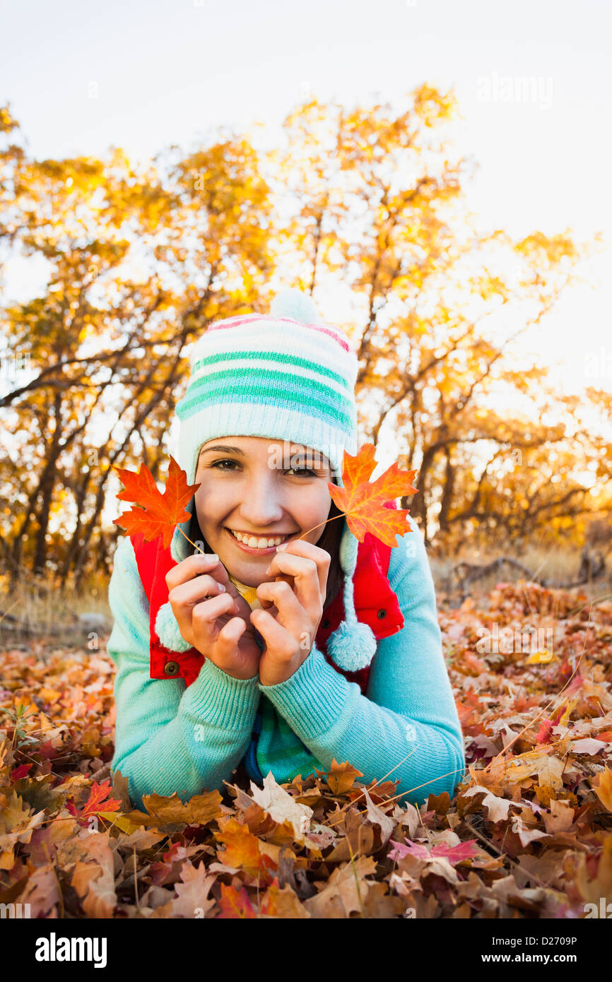 Woman lying holding maple leaf hi-res stock photography and images - Alamy