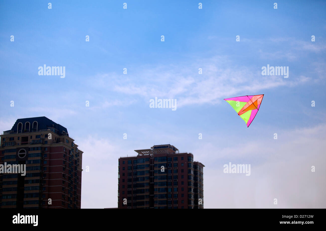Kite flying above the roof of skyscraper Stock Photo - Alamy