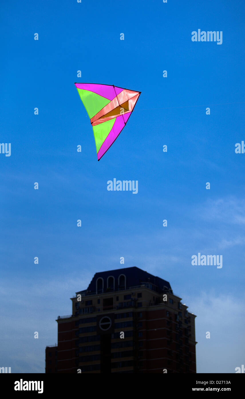 Kite flying above the roof of skyscraper Stock Photo - Alamy