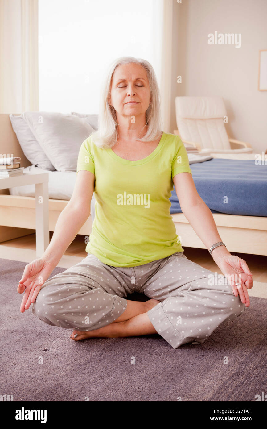 Senior woman in lotus position hi-res stock photography and images - Alamy