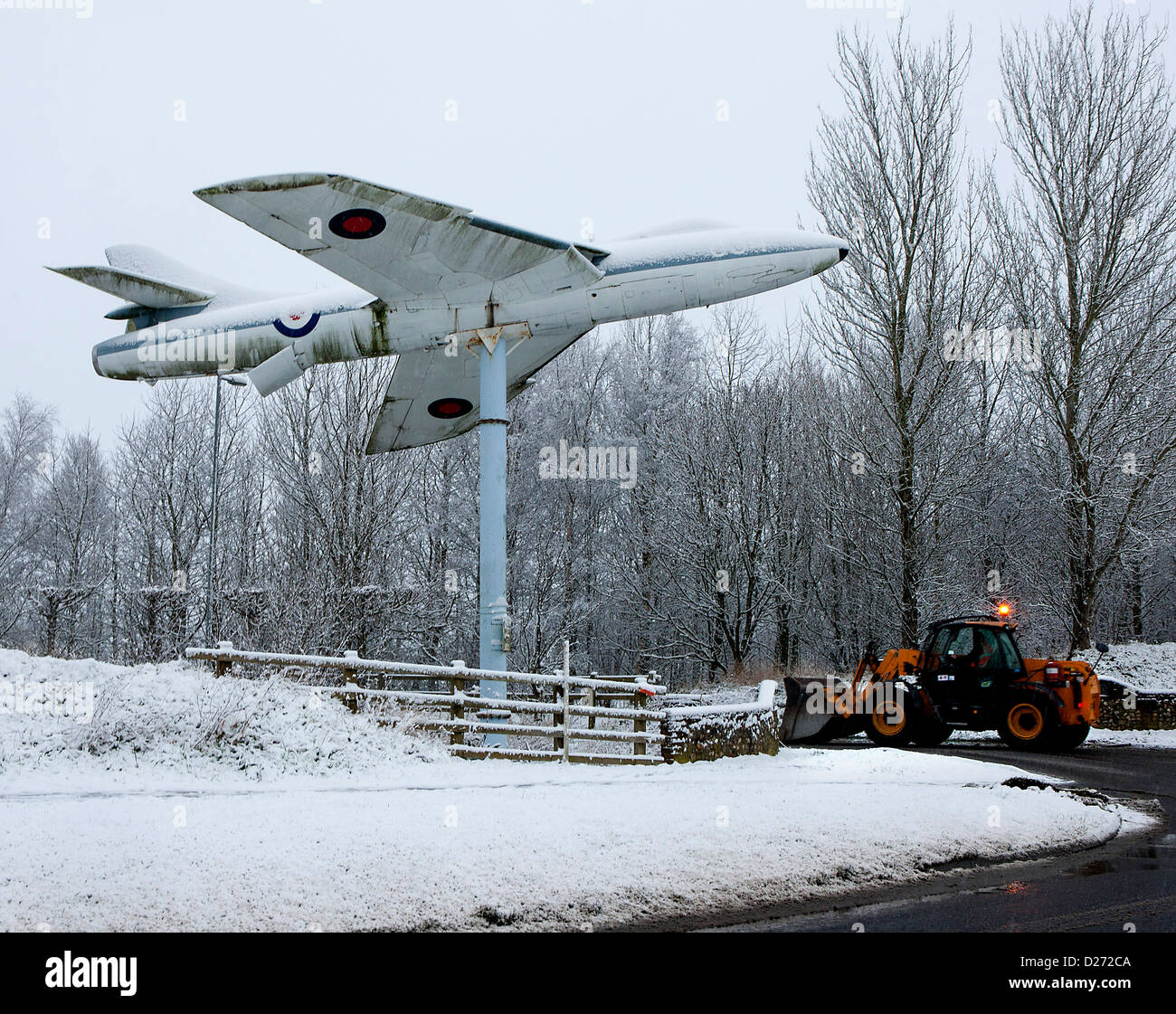 Snow being cleared by the side of a Hawker Hunter jet mounted on a pole ...