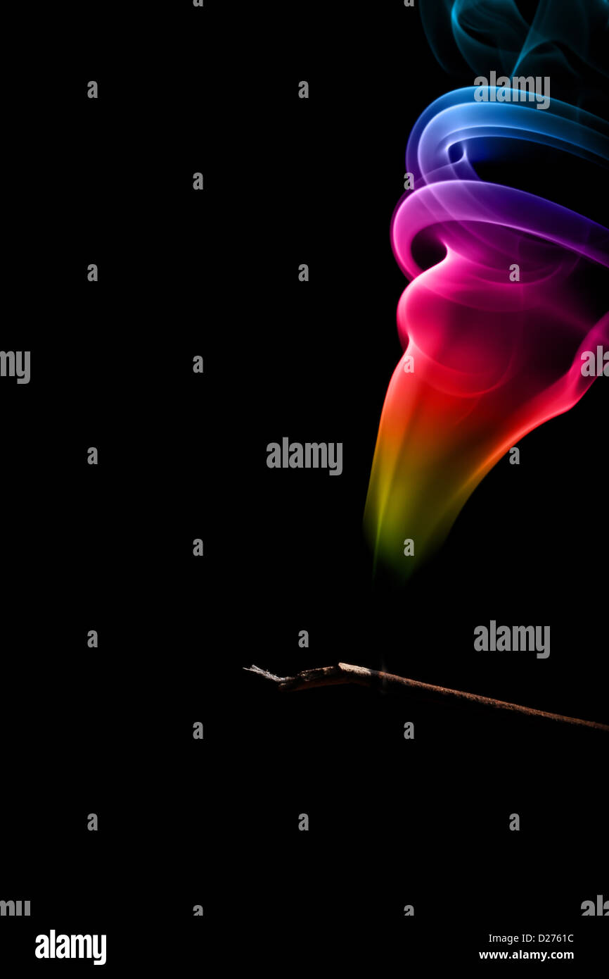 Incense Stick with Colorful Abstract Smoke Trail on black background ...