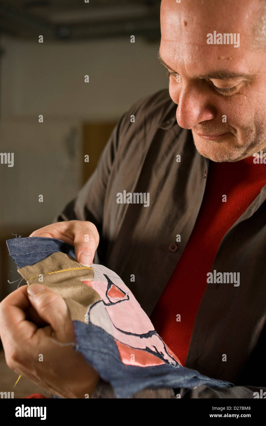 Male embroidery artist working on an artwork at West Dean College ...