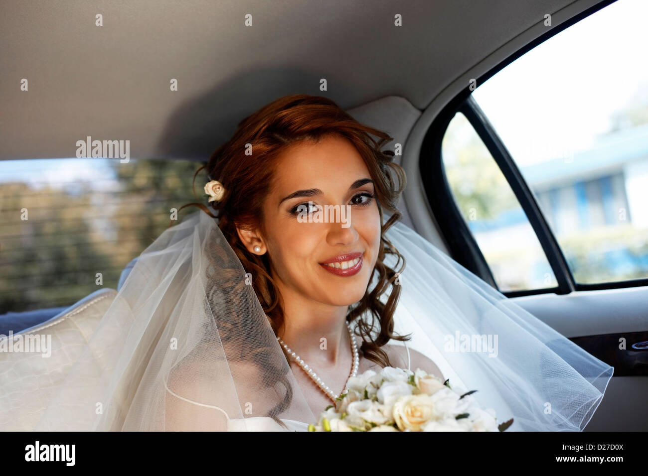 The beautiful smiling bride in the automobile Stock Photo - Alamy