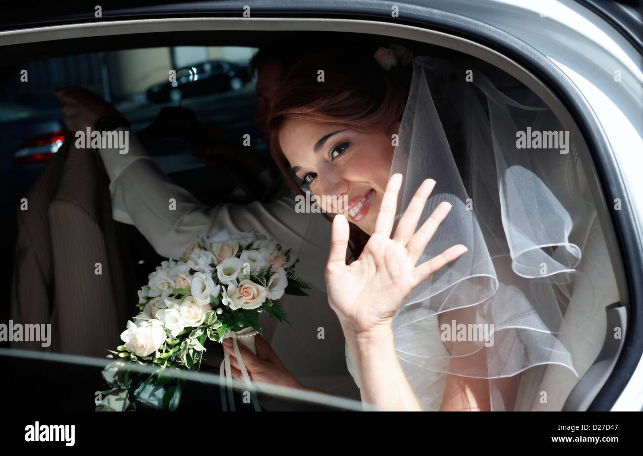 Beautiful bride in car Stock Photo - Alamy
