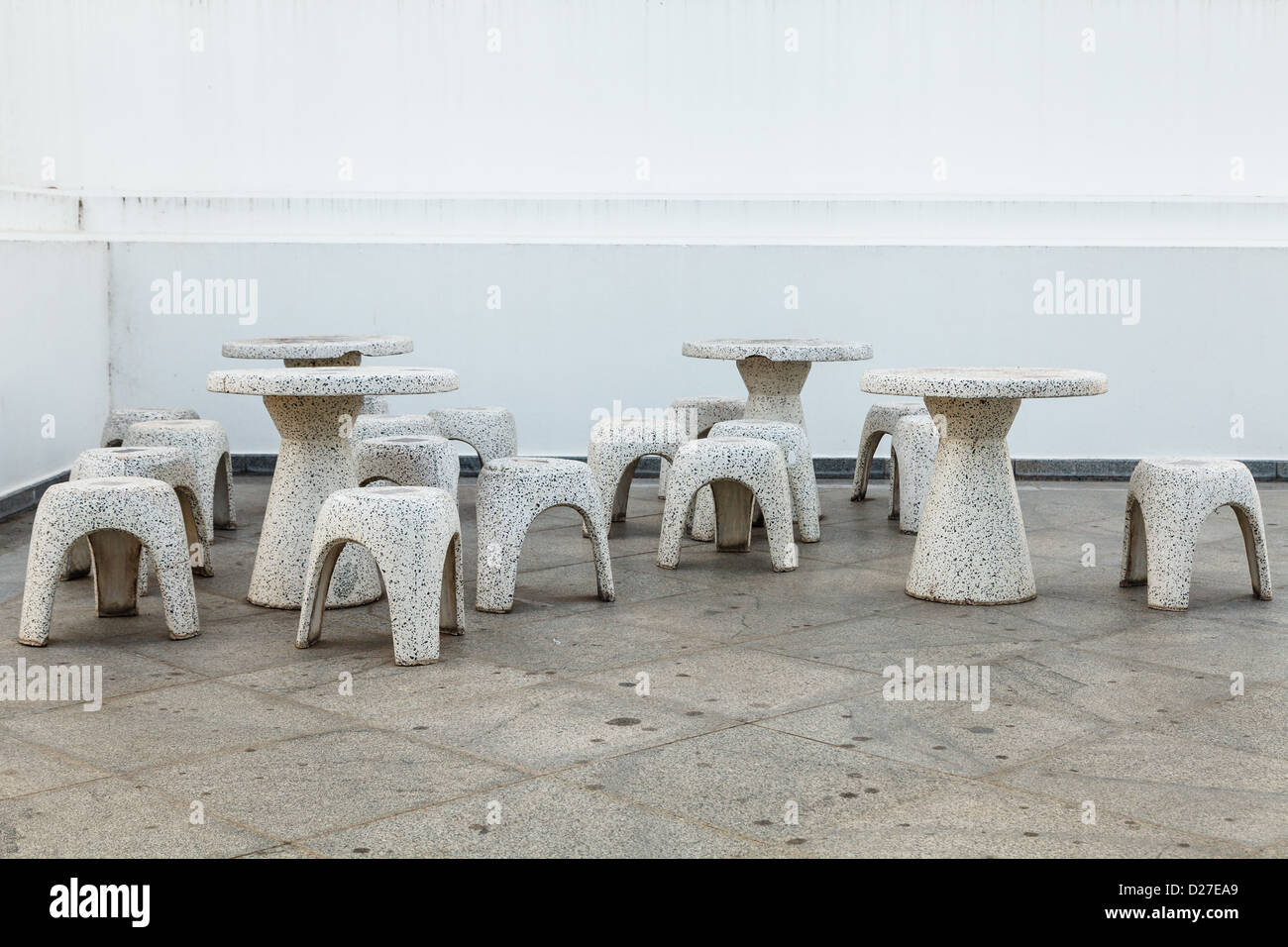 Group of stone tables and stools on the floor Stock Photo - Alamy
