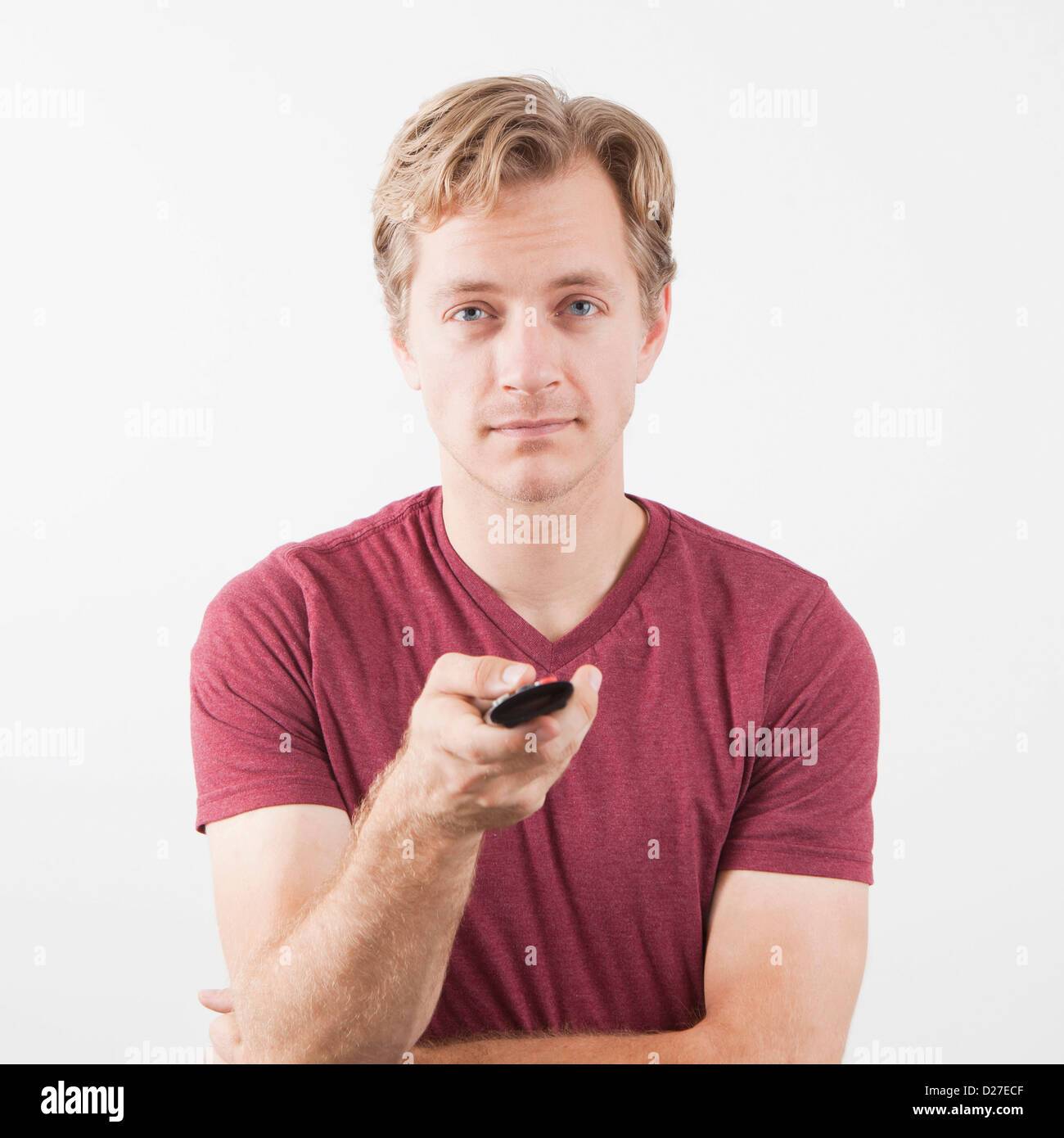 Man holding remote control Stock Photo - Alamy