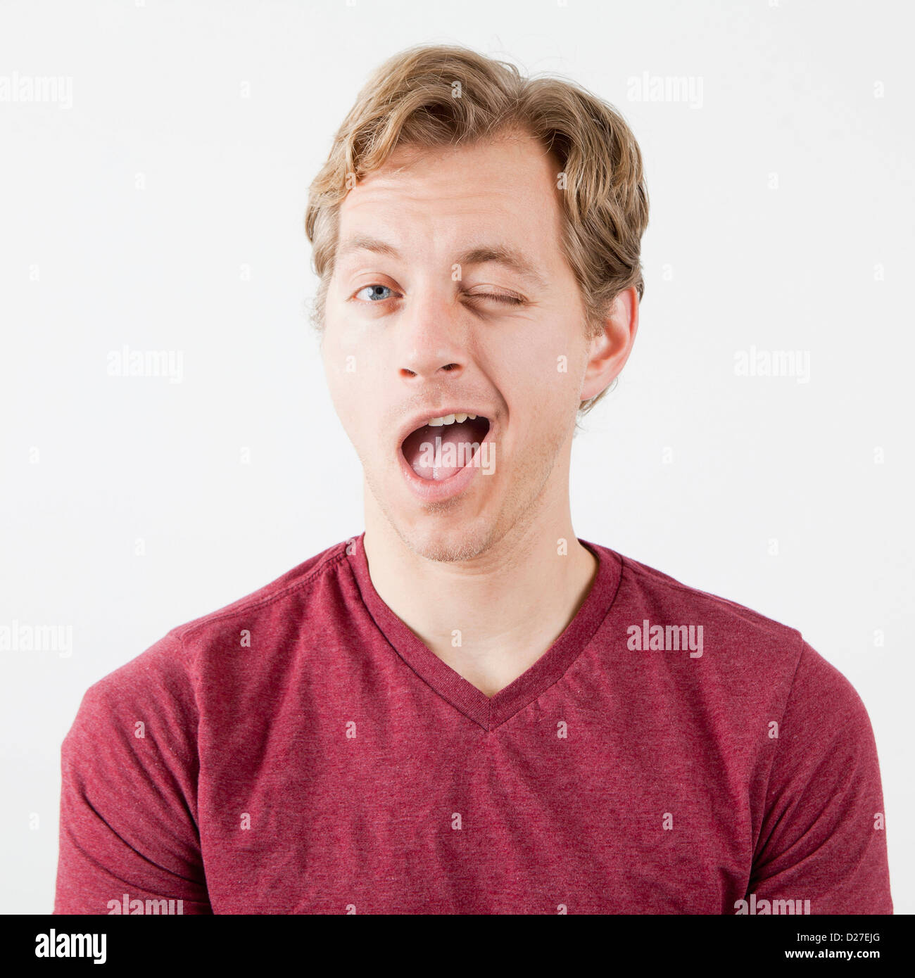 Portrait of man winking Stock Photo - Alamy