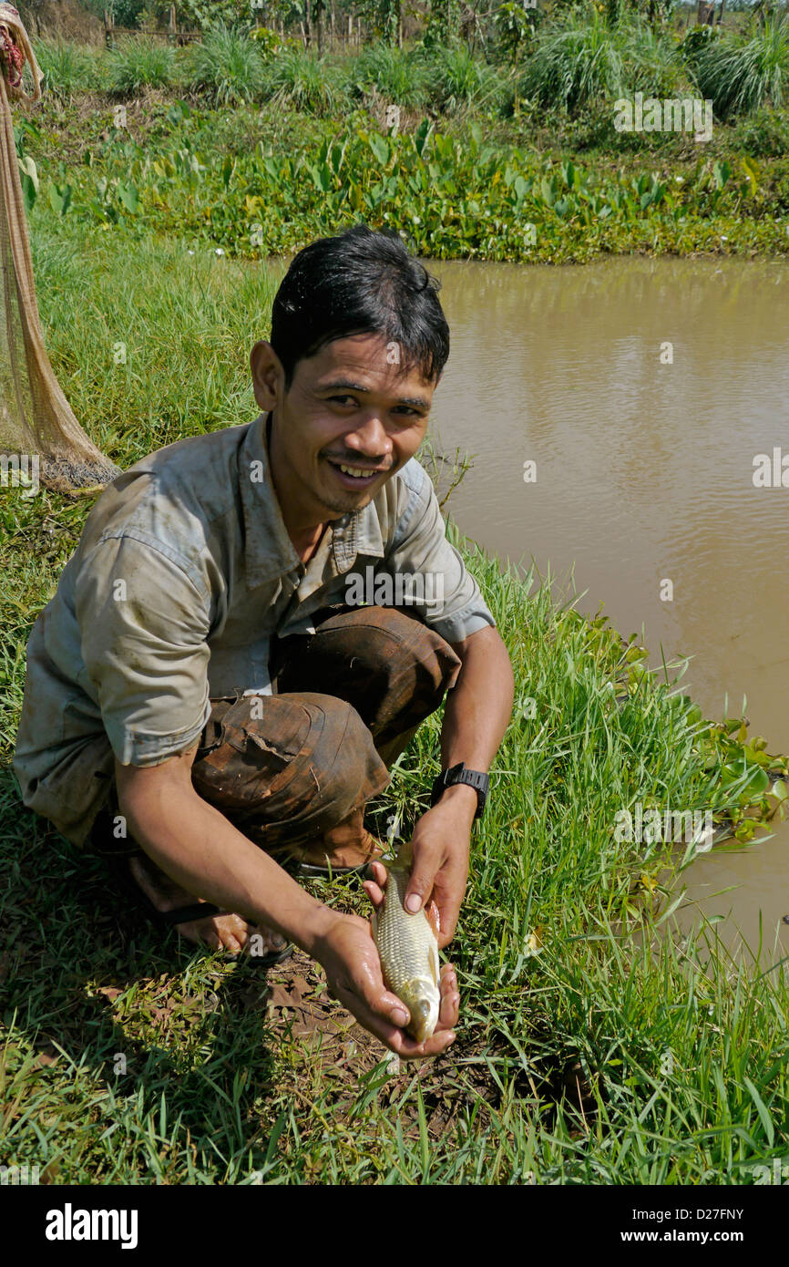 Cambodia - man with fish caught in his pond Stock Photo - Alamy