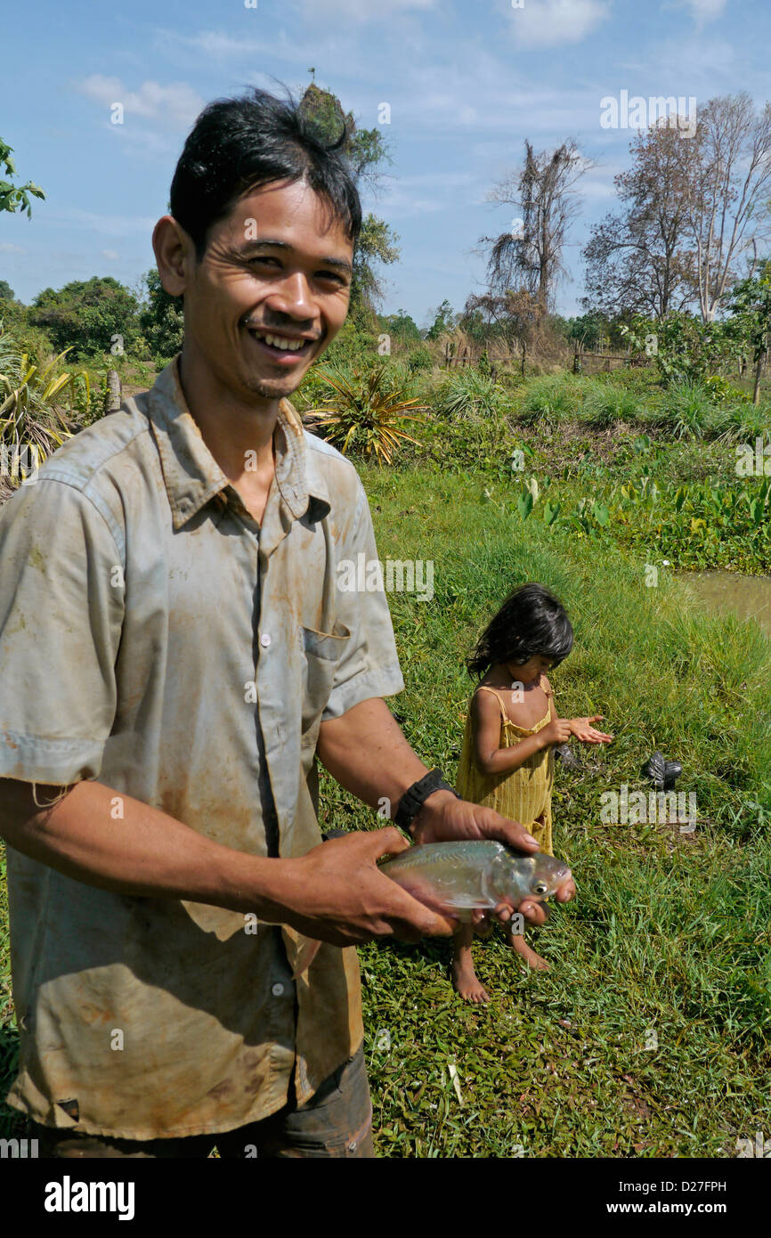 Cambodia - man with fish caught in his pond Stock Photo - Alamy
