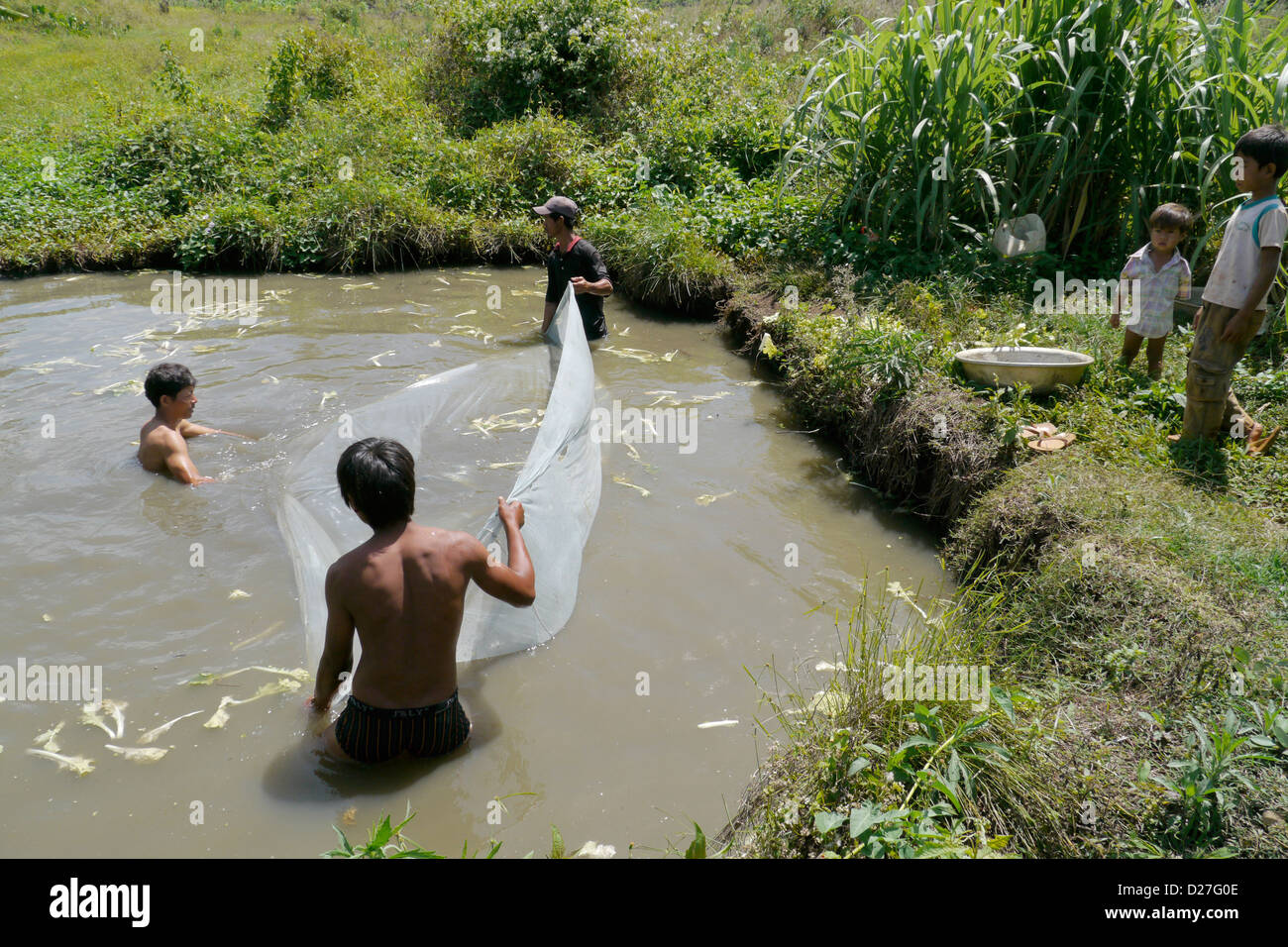 Cambodia - men fishing in village pond Stock Photo - Alamy