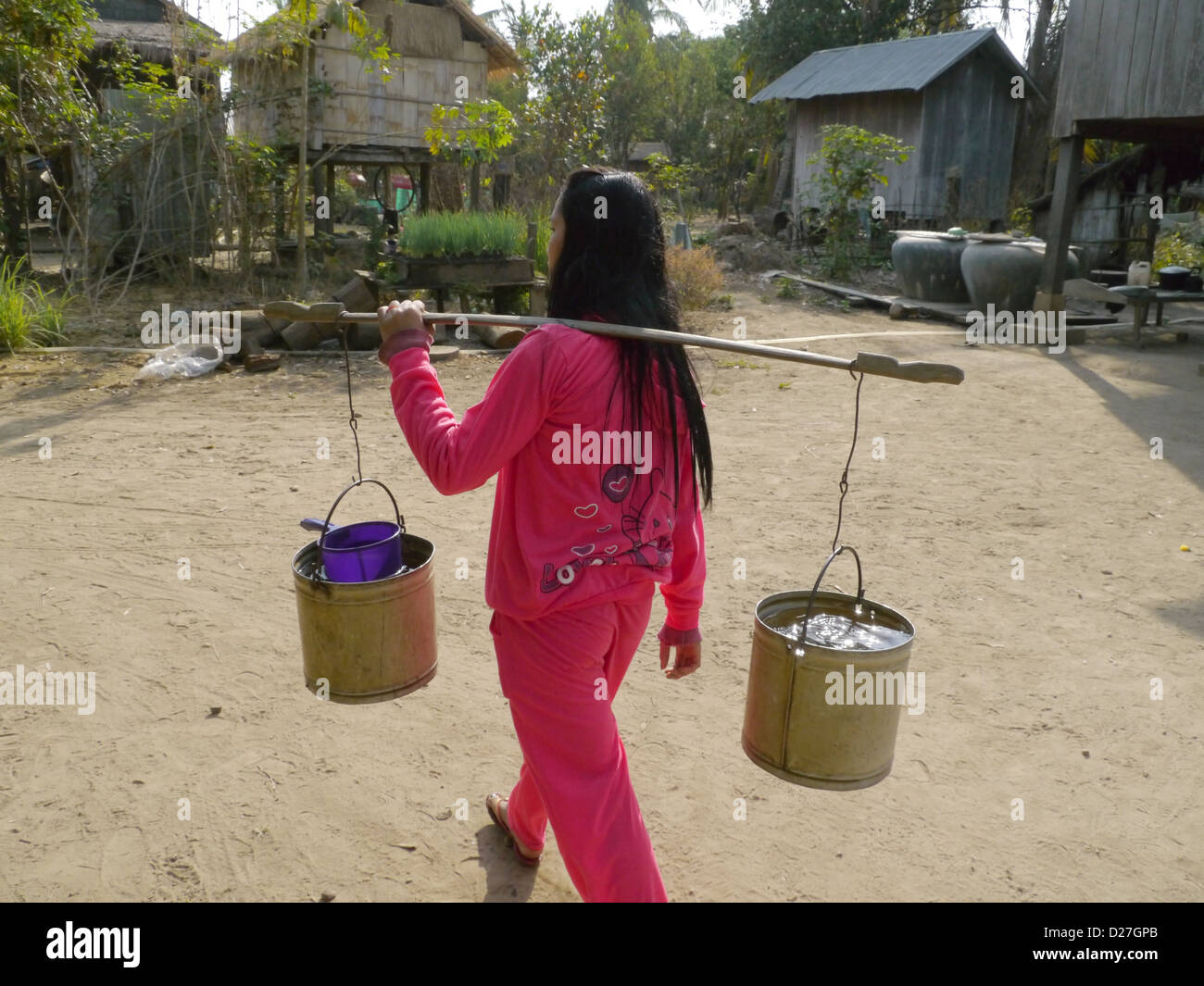 Cambodia - girl carrying water Stock Photo - Alamy