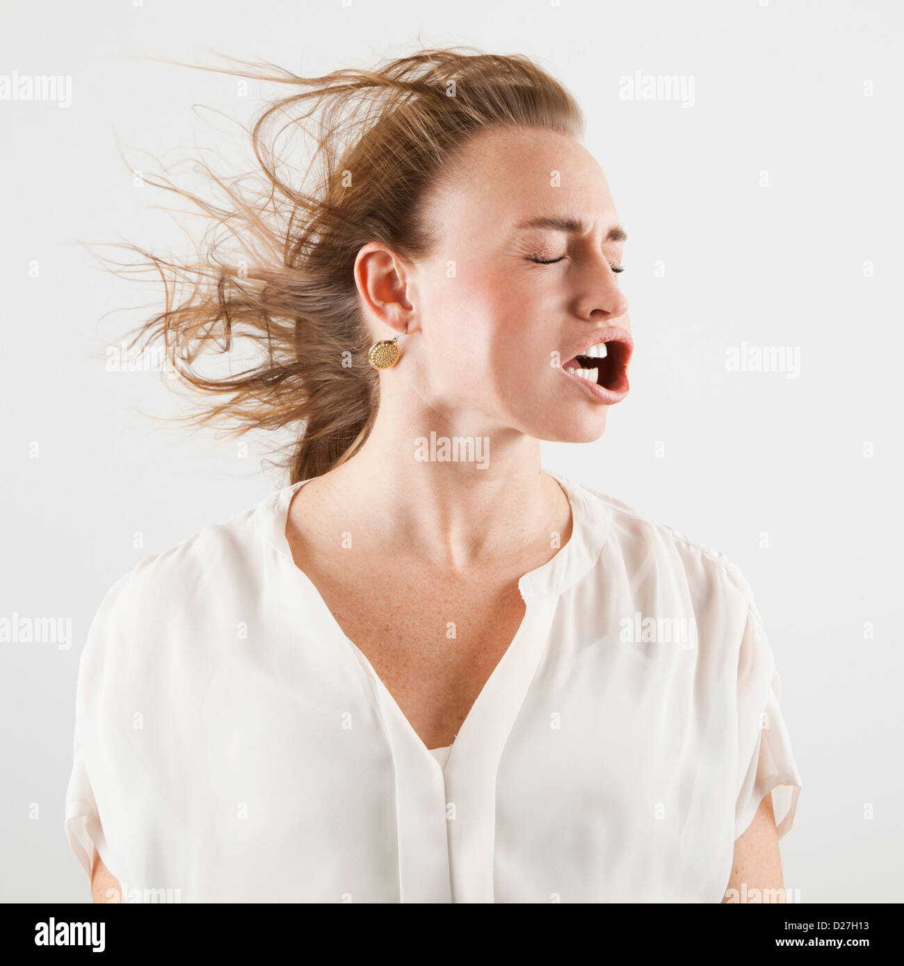 Studio shot of woman with windblown mouth Stock Photo - Alamy