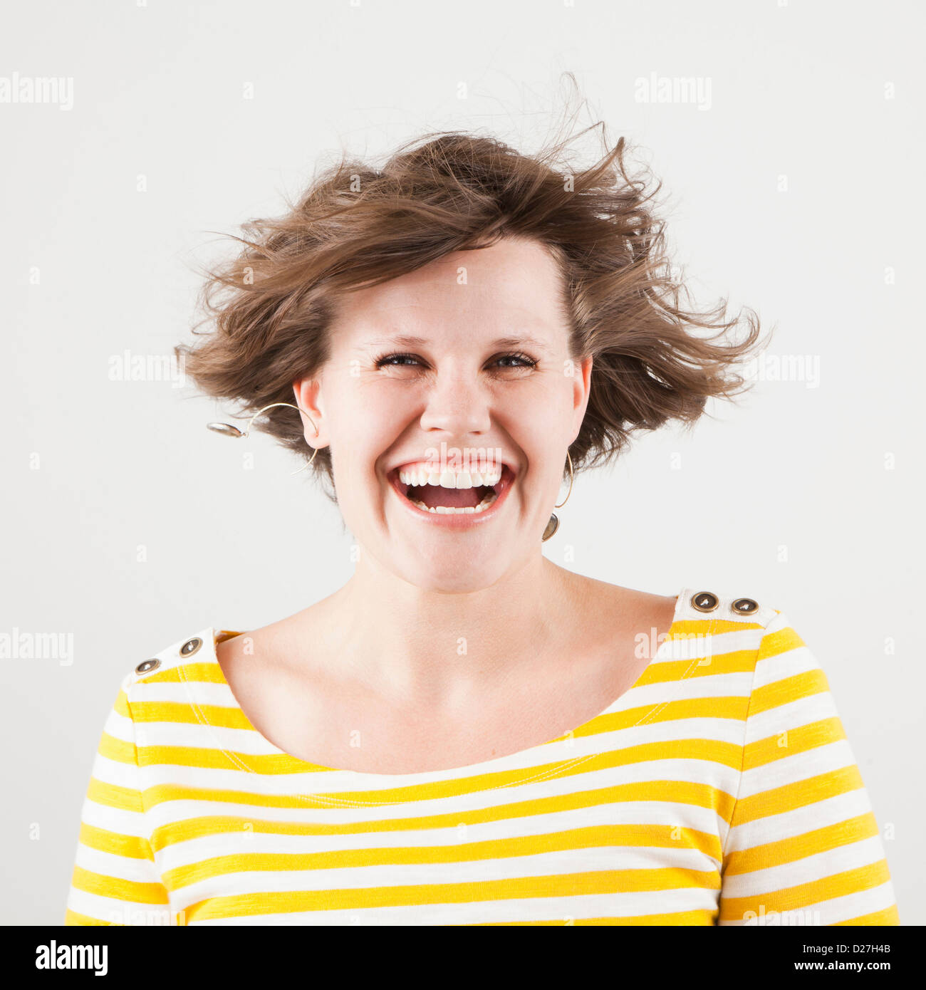 Studio portrait of woman laughing Stock Photo - Alamy