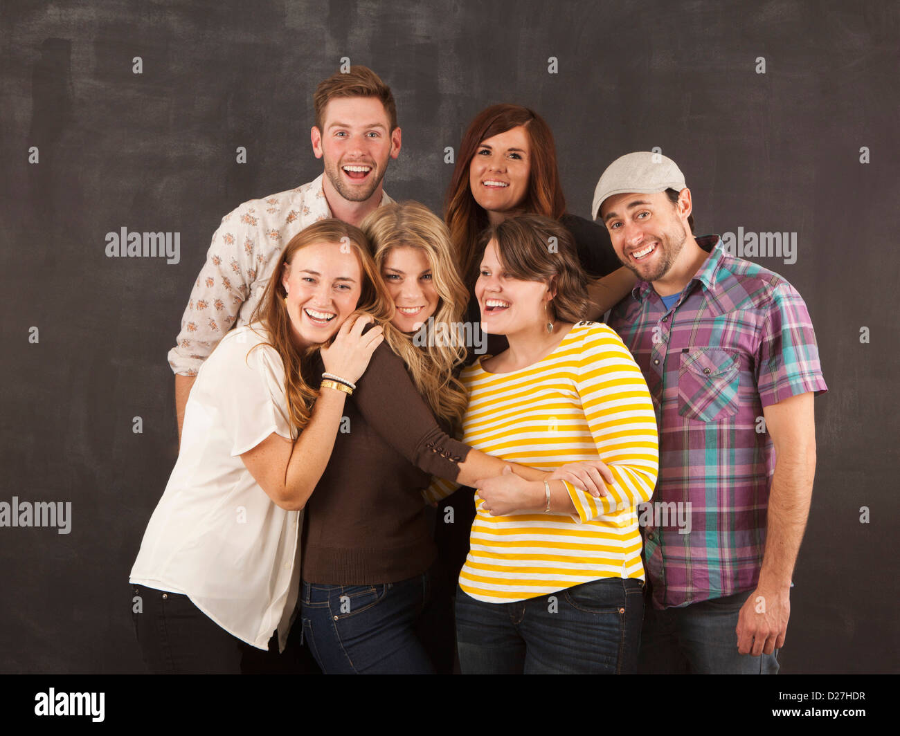 Studio portrait of group of friends embracing Stock Photo - Alamy