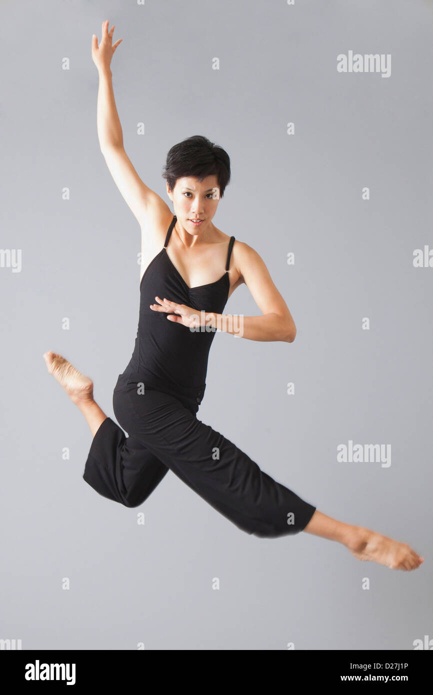 Studio Shot of jumping woman Stock Photo - Alamy