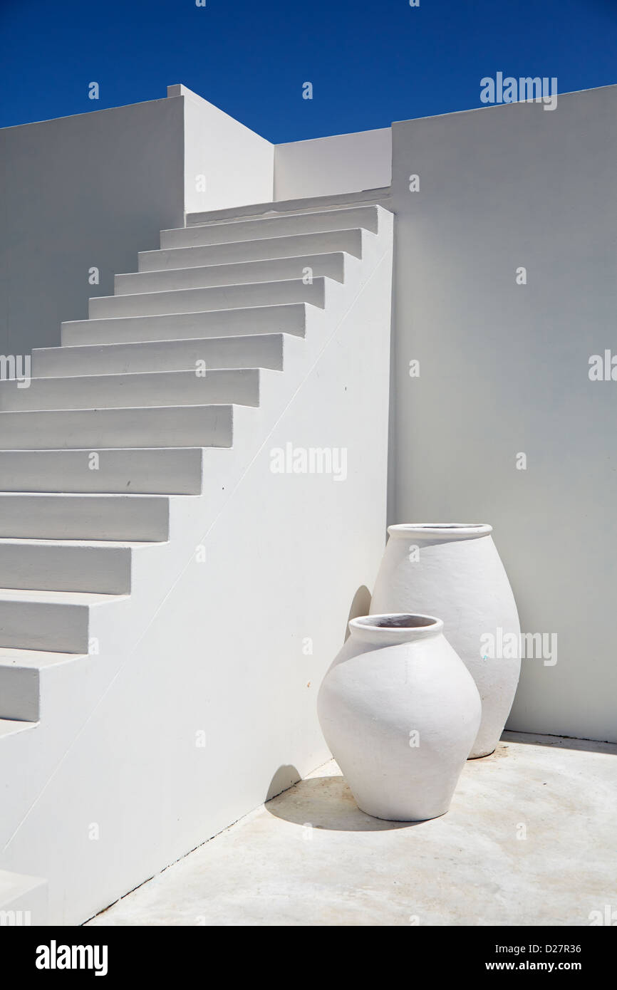White stone stair case with walls and vases against a blue sky Stock ...