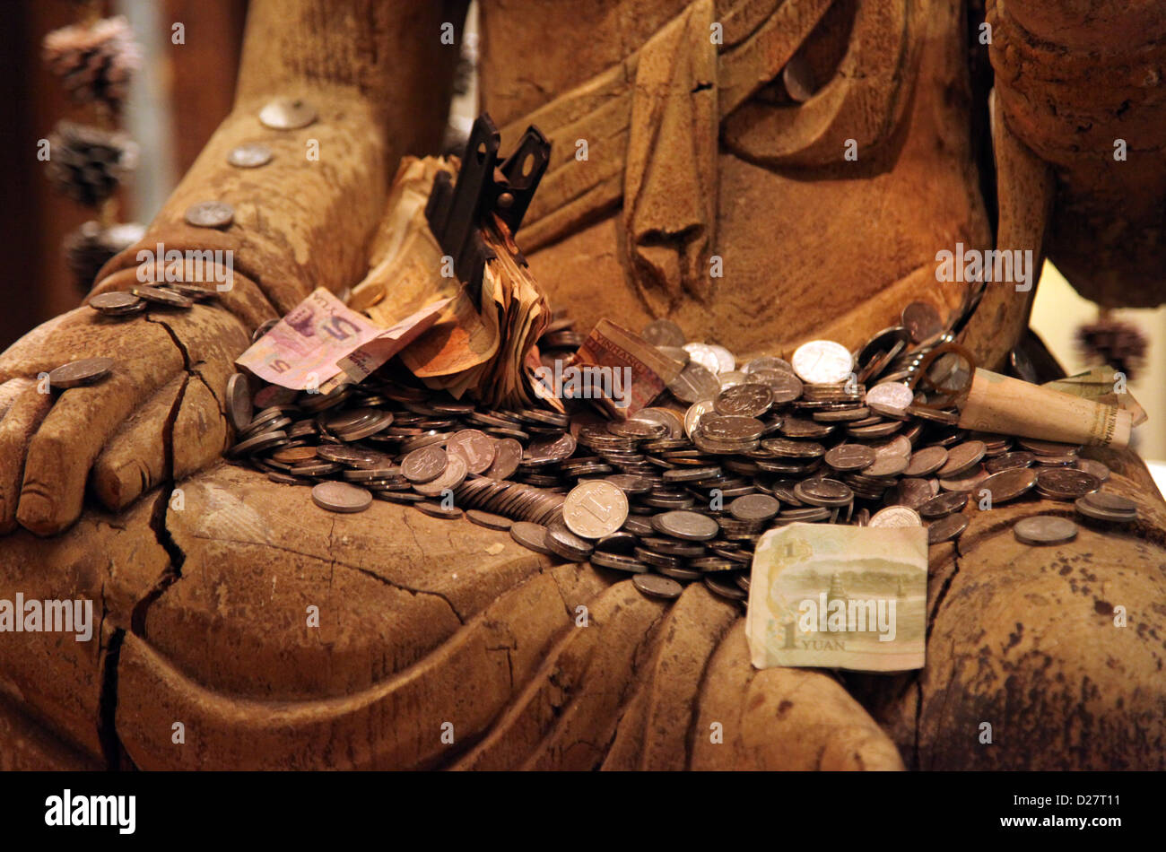 It's a photo of Close up on coins and notes that are on the hands of a ...