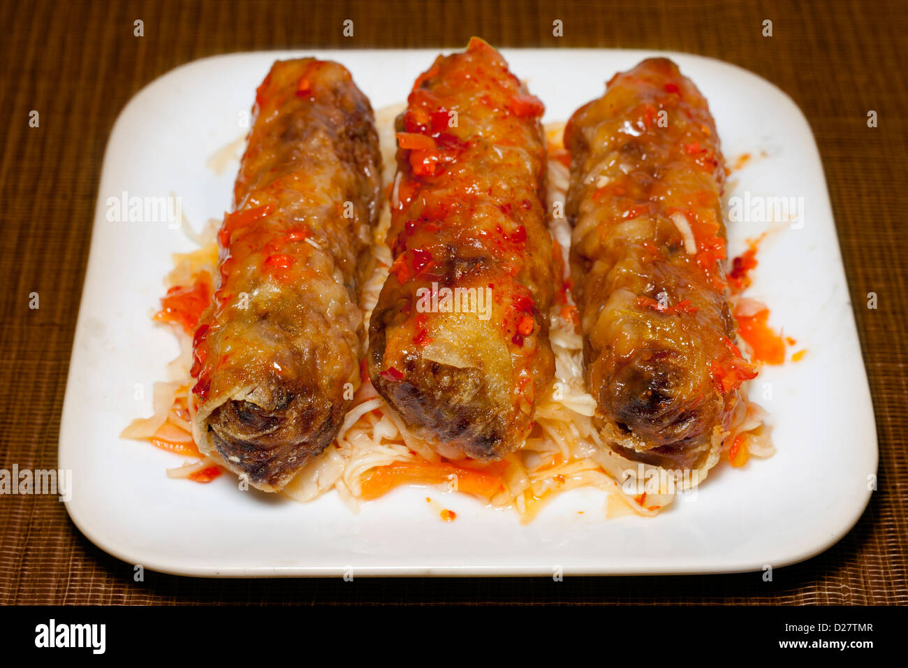 Spring rolls closeup with sauce on bamboo mat Stock Photo - Alamy