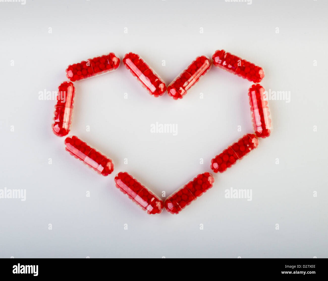Pills filled with red candy Stock Photo - Alamy