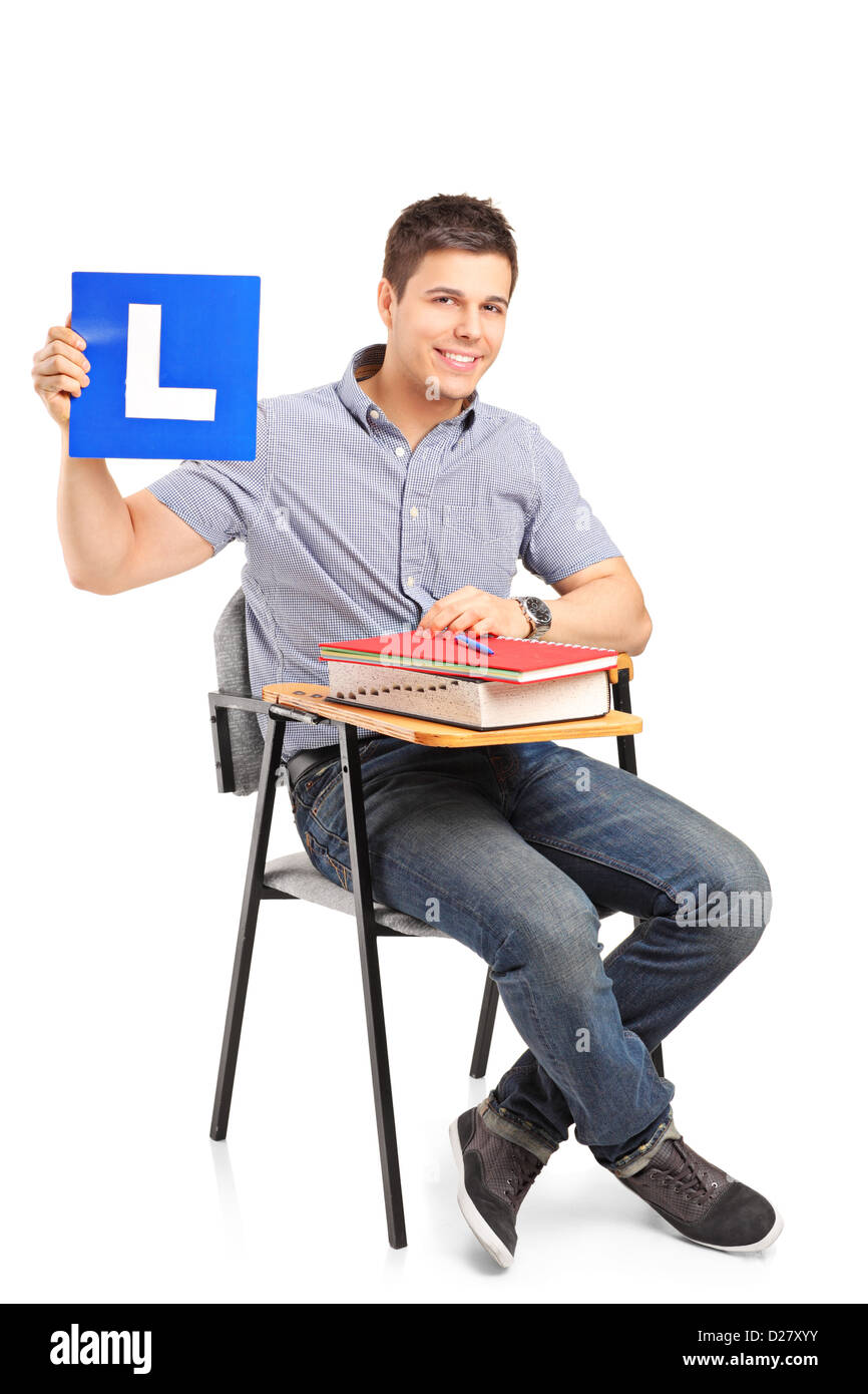A young student sitting on a school chair and holding a L plate ...