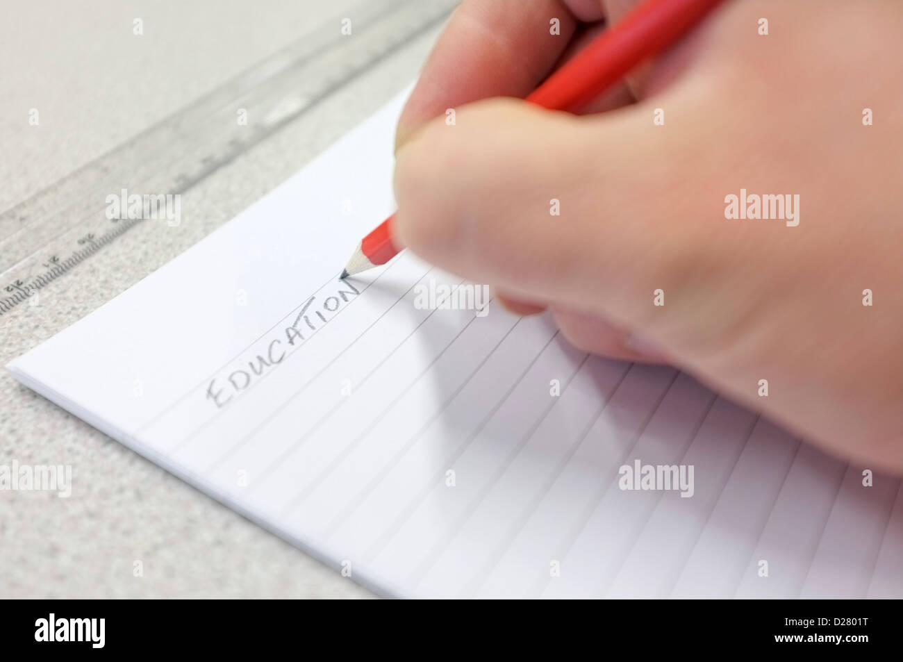 Pupil/Student/Learner writing on paper with a pencil Stock Photo - Alamy