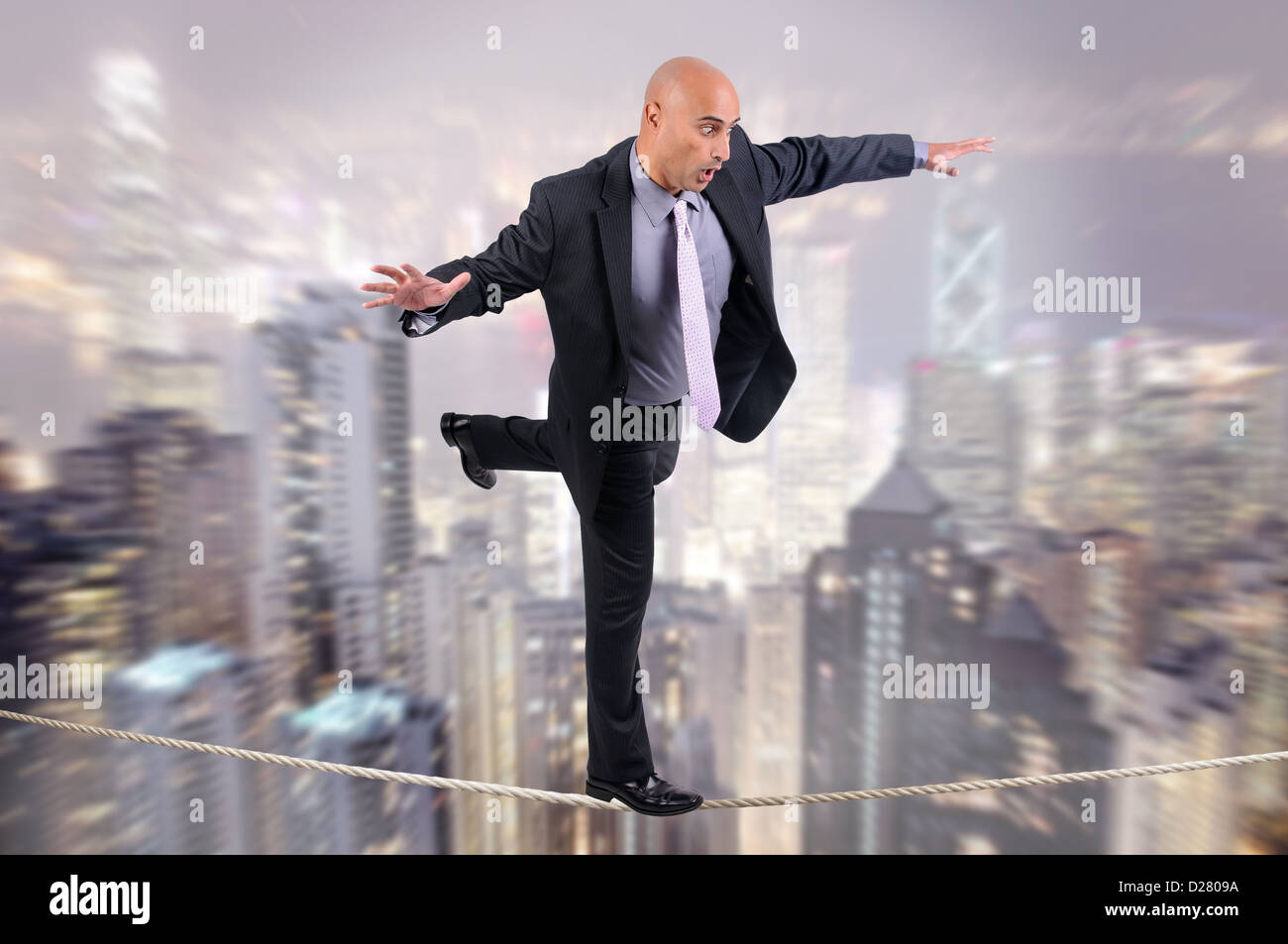 Businessman walking a rope in despair Stock Photo - Alamy