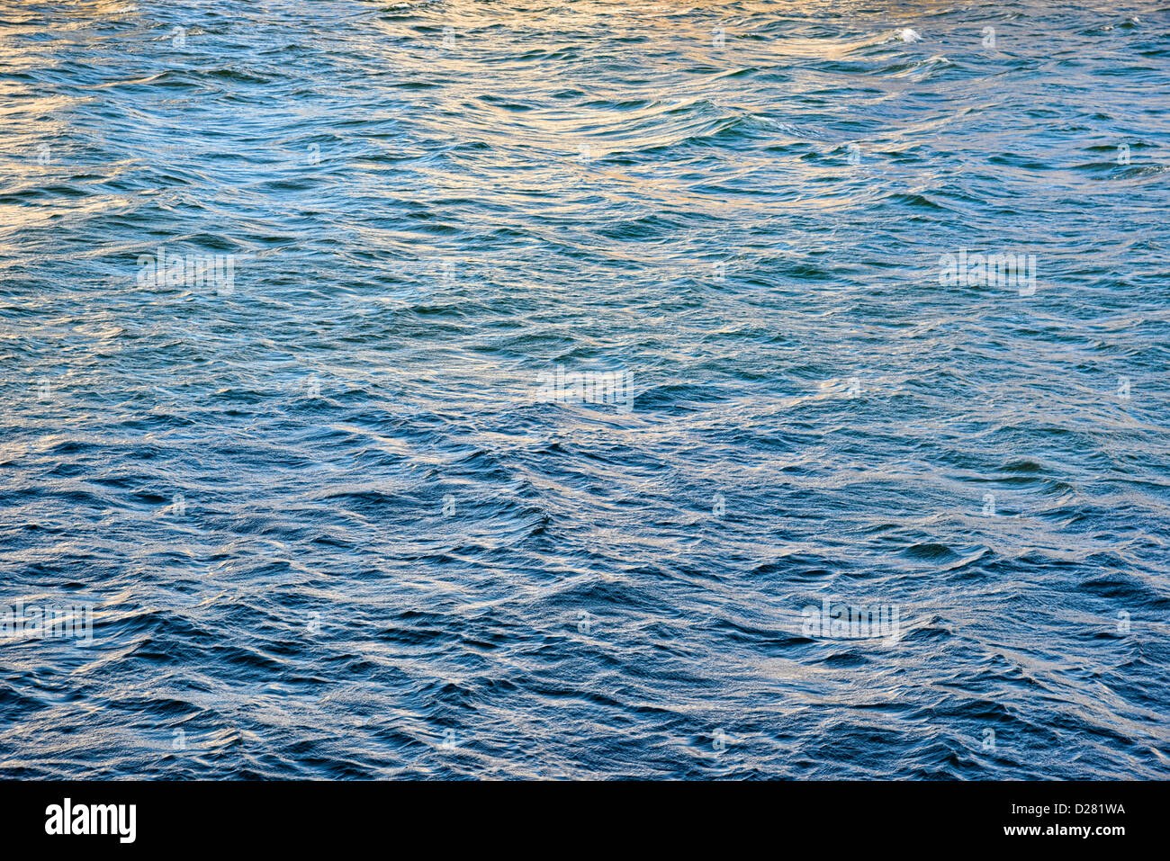 water waves with sun reflection at dusk Stock Photo - Alamy