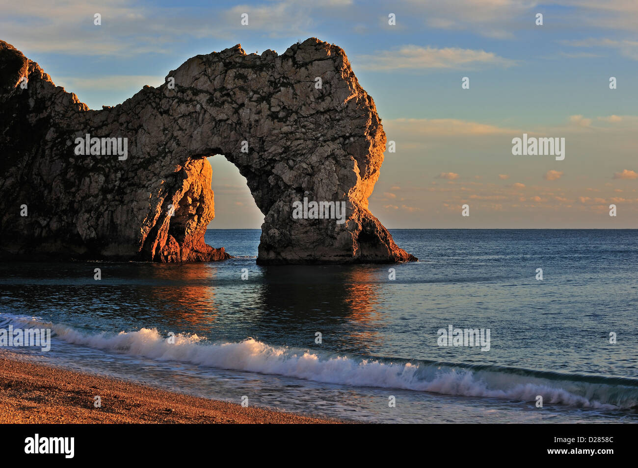 Durdle Door, a natural limestone arch at sunset along the Jurassic ...