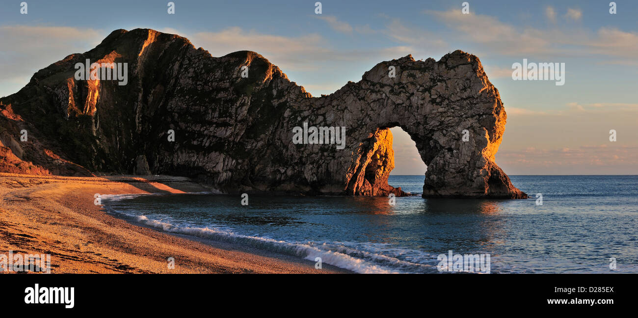 Durdle Door, a natural limestone arch at sunset along the Jurassic ...
