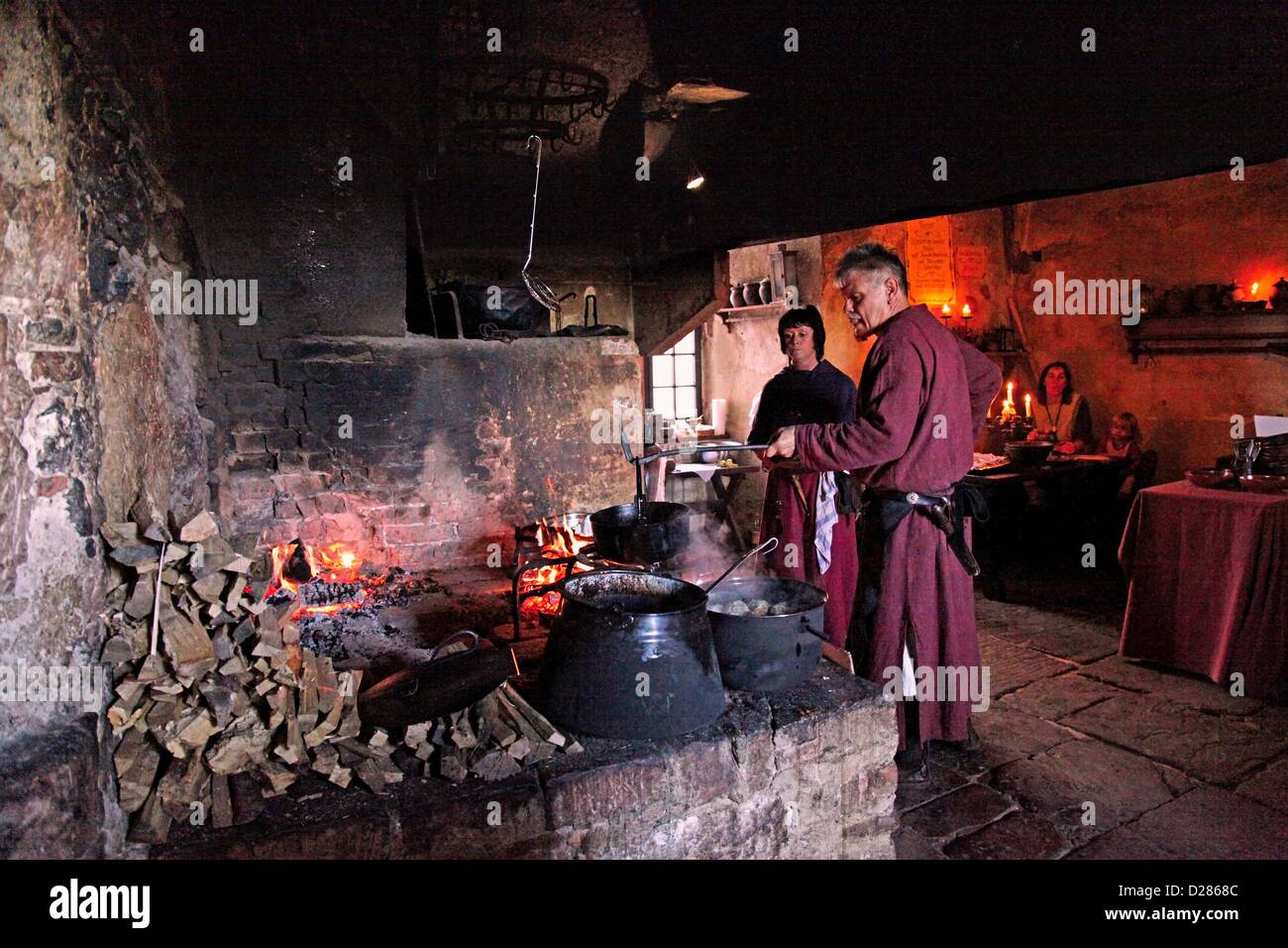 medieval cooking area, cooks in medieval clothing, medieval decorated ...