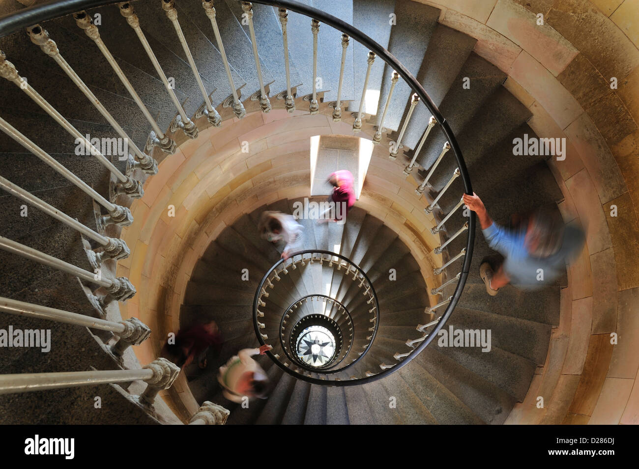 Tourists climbing spiral staircase inside the lighthouse Phare des ...
