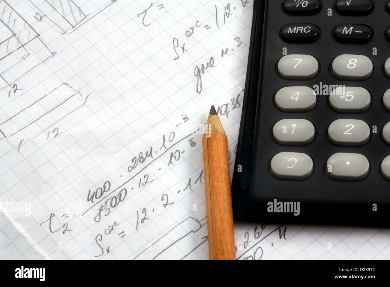 Calculator pen and a piece of paper after home work Stock Photo - Alamy