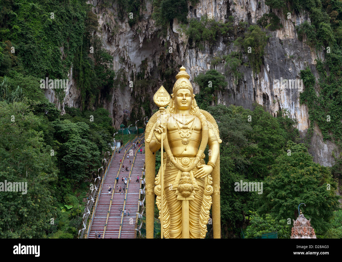 A golden statue towers in front the entrance to the round 300 steps ...